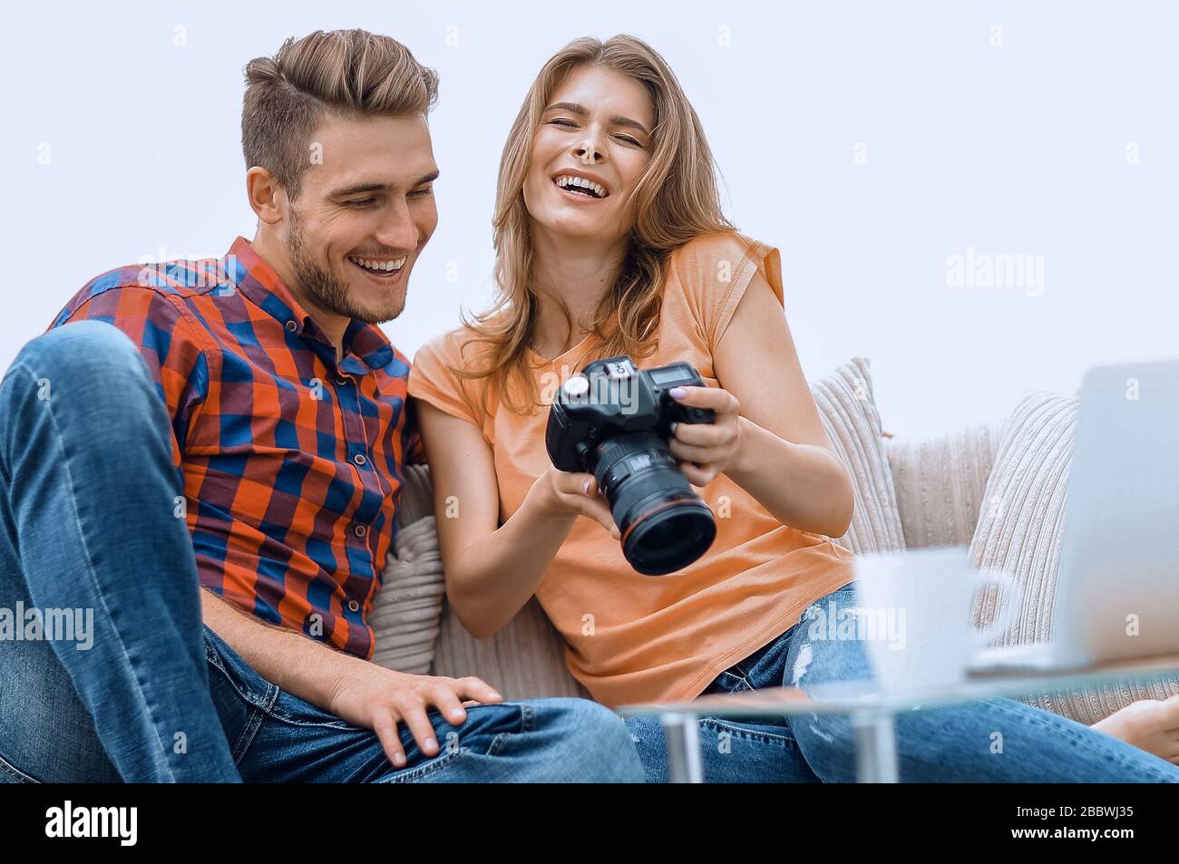 happy young couple checks photos on photos the camera Stock Photo - Alamy