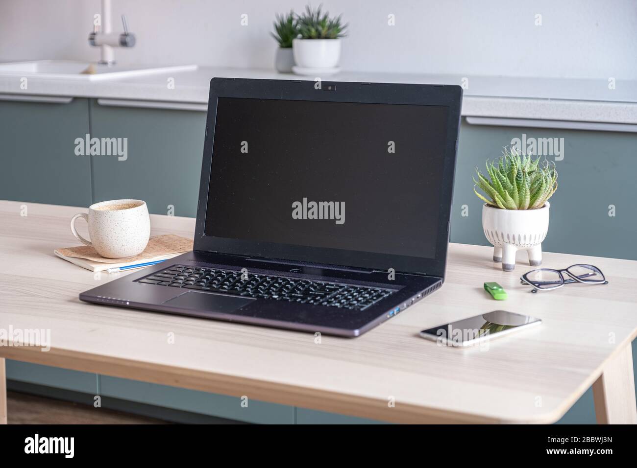 Home office working space on a kitchen table Stock Photo - Alamy