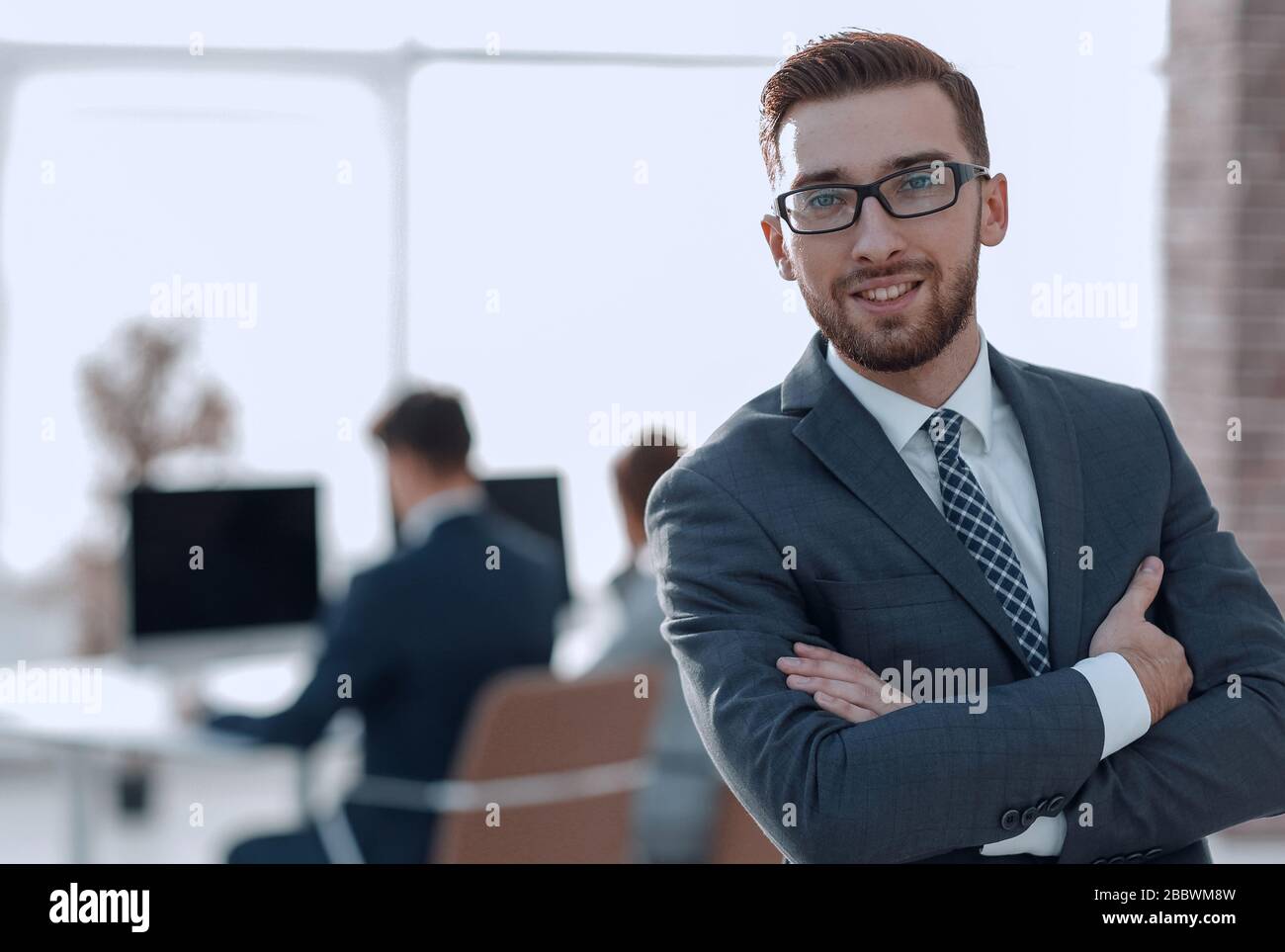 successful businessman on background of office Stock Photo - Alamy