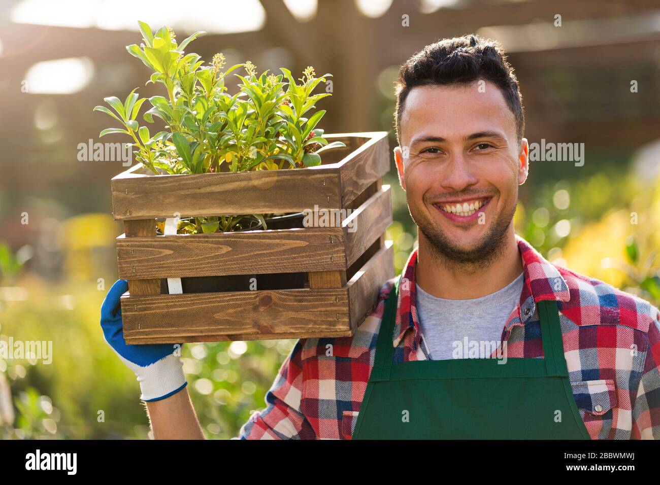 Smiling employees in garden center Stock Photo - Alamy