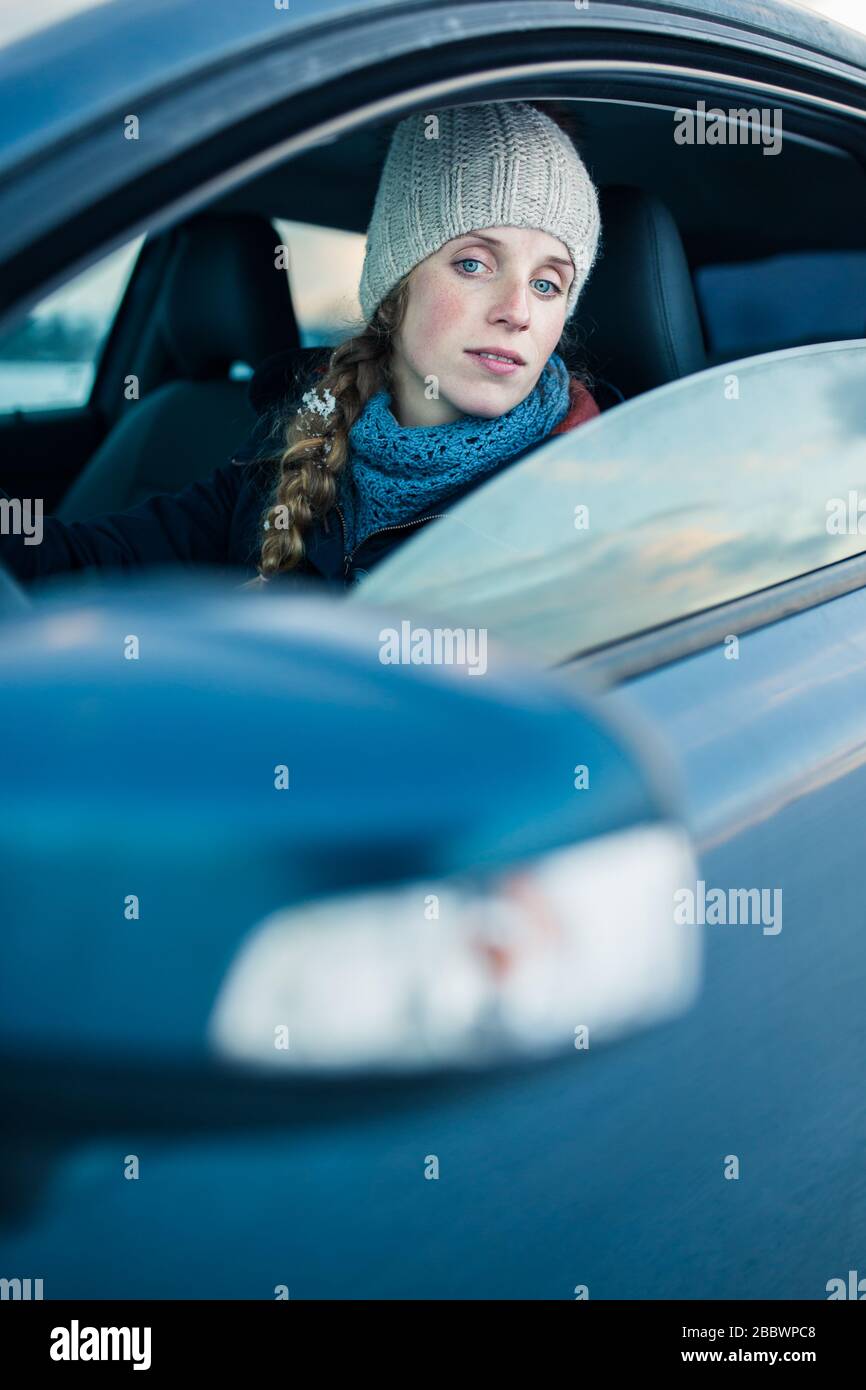 Woman driving a car - female driver at a wheel of a modern car, looking ...