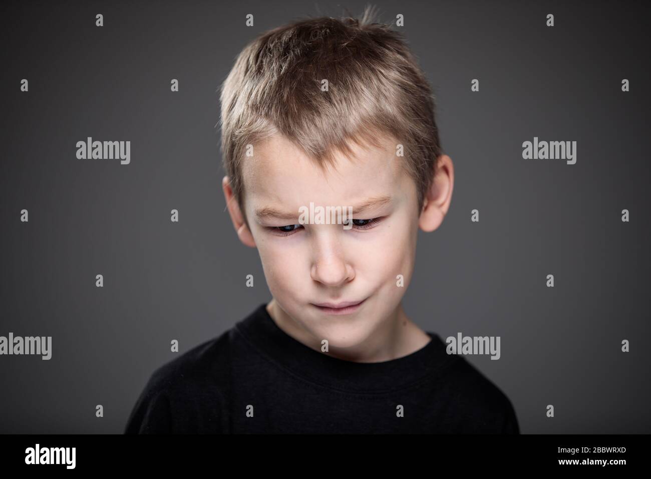 Grief-stricken little boy - feeling intense sorrow, remorse, sadnesss ...