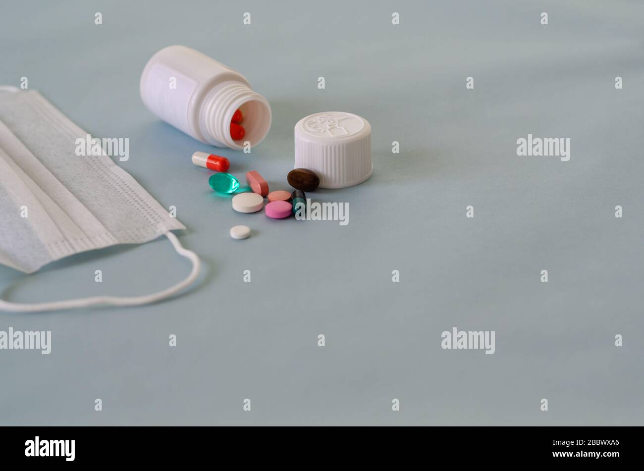 Multi color of pills, painkiller, medicine on blue background.Space for ...