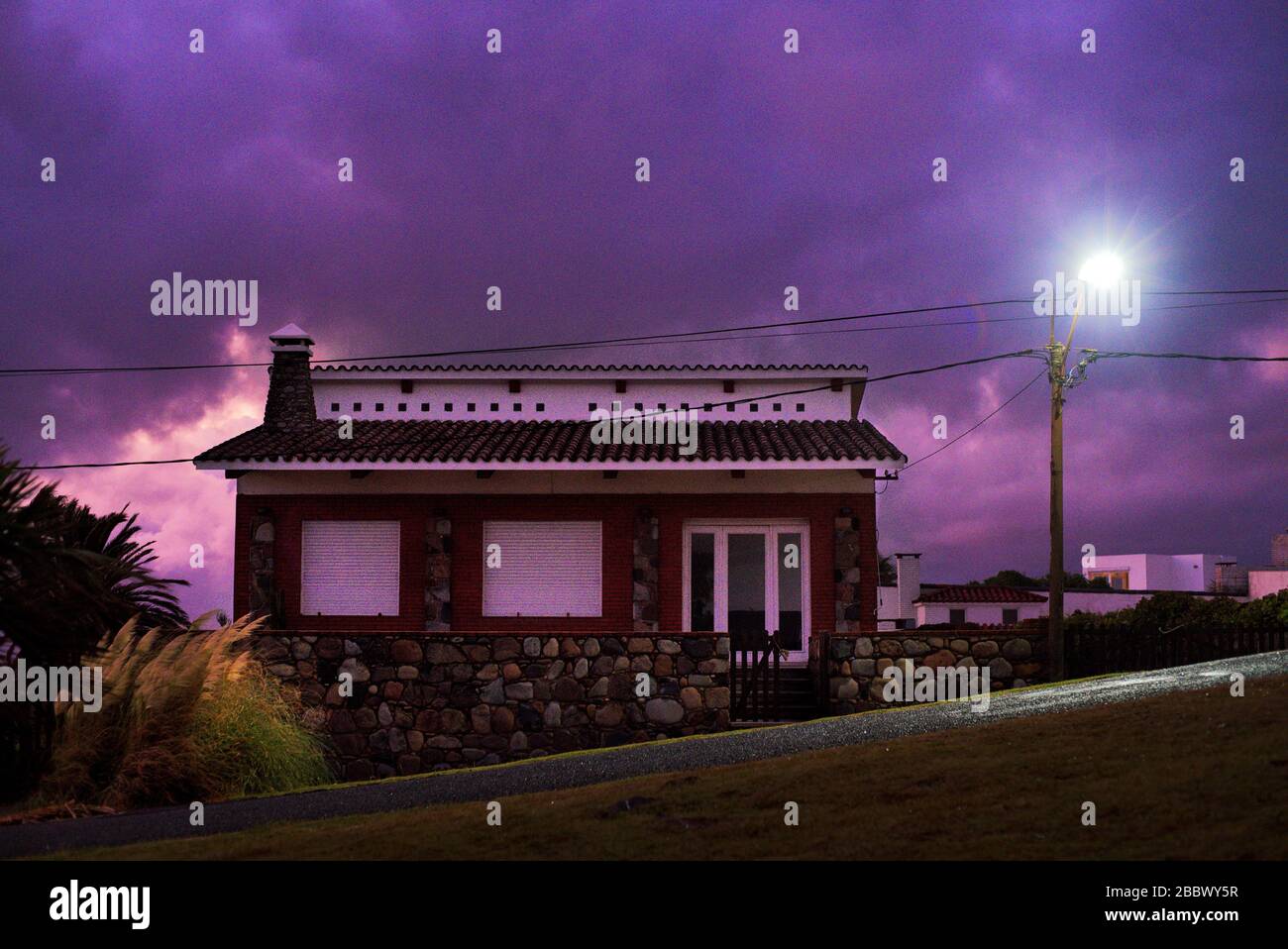 house with purple sky Stock Photo - Alamy