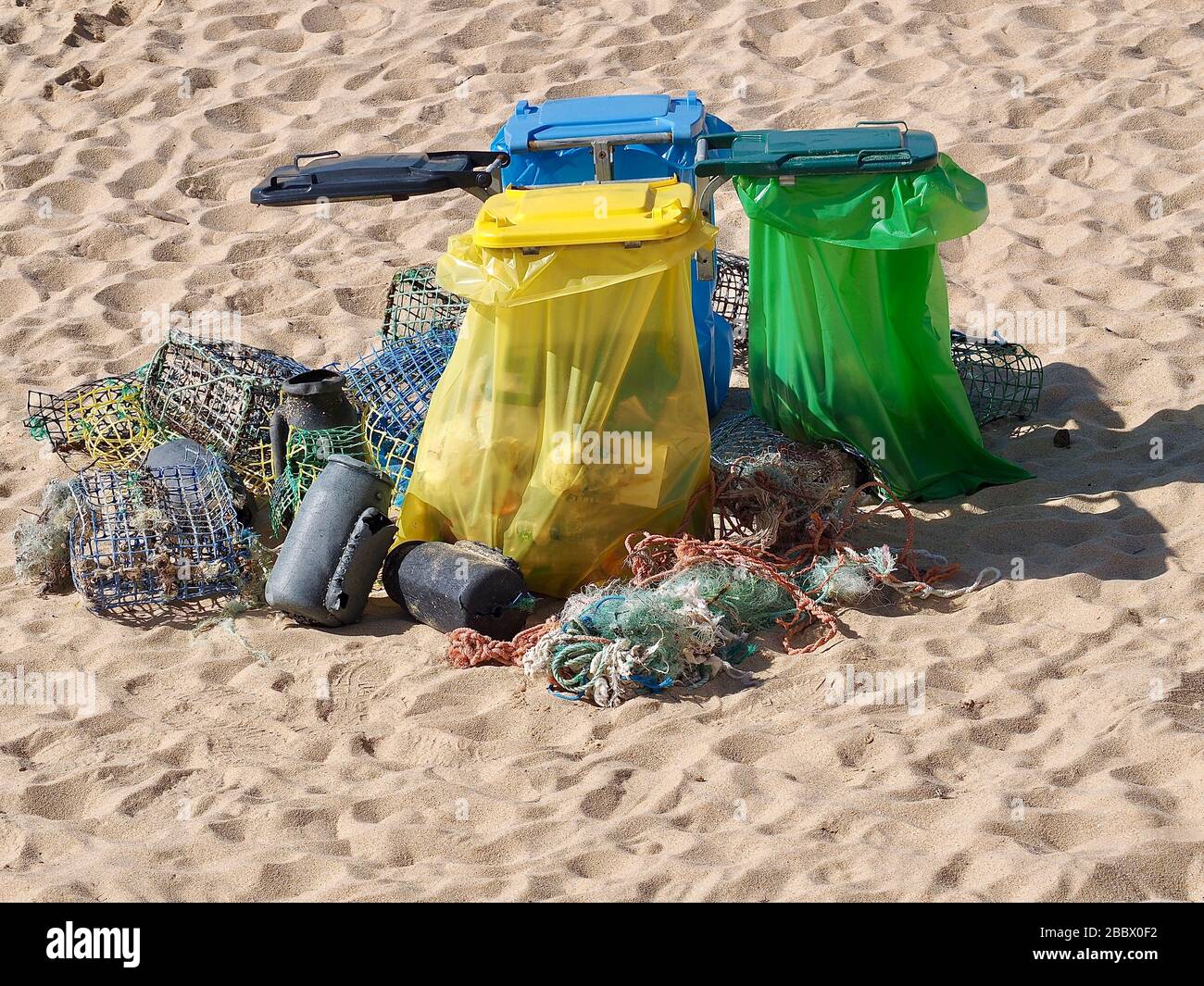 Waste separation at a beach with fish traps Stock Photo - Alamy
