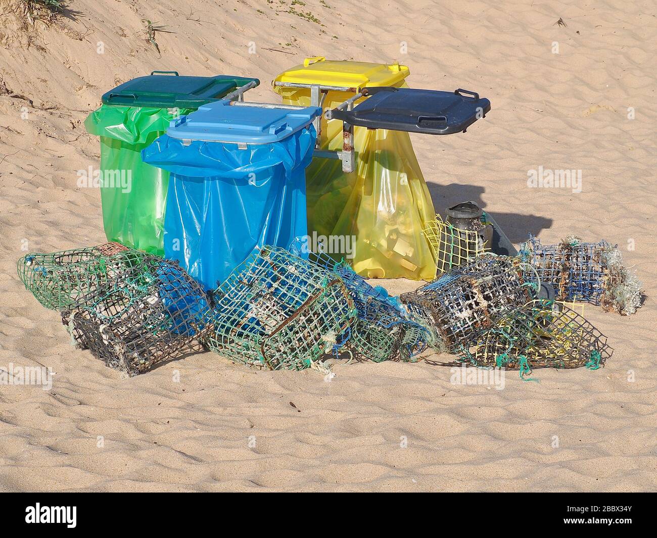 Waste separation at a beach with fish traps Stock Photo - Alamy