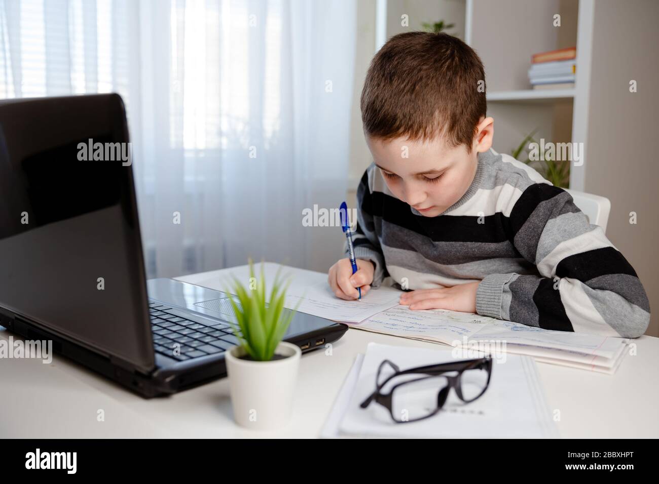 Online education and distance learning. Boy doing school homework Stock ...