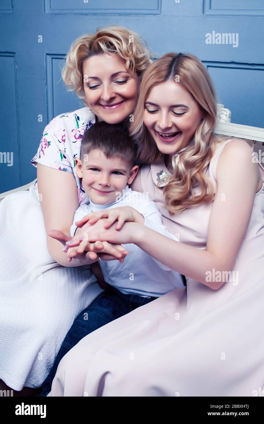 happy smiling blond family together posing cheerful on blue background ...