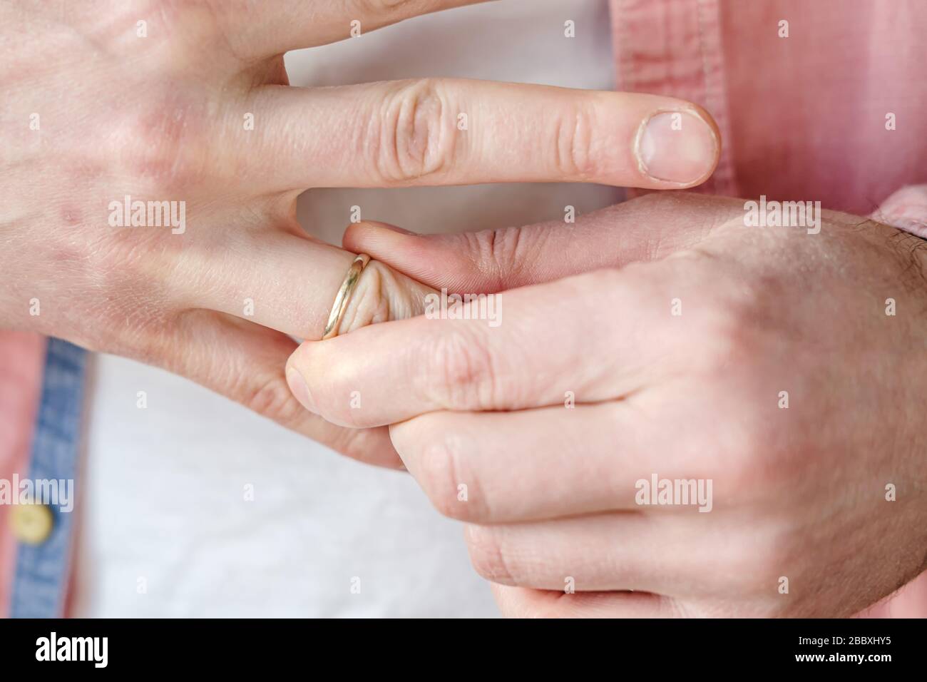 Man removes a gold wedding ring from his finger. Concept of family ...