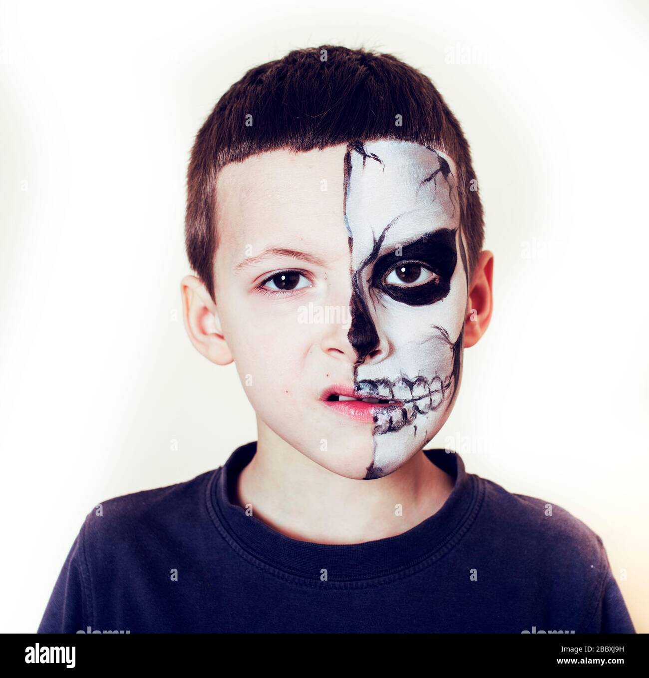 little cute boy with facepaint like skeleton to celebrate halloween ...