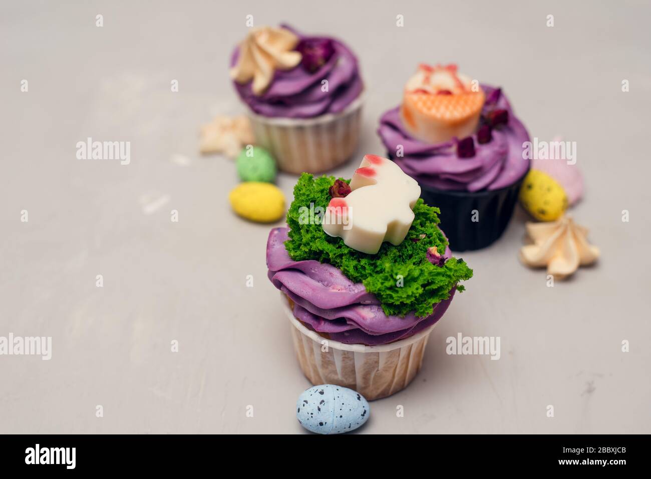 Easter food concept. Idea for kids. Decorating Easter bunny cupcakes ...