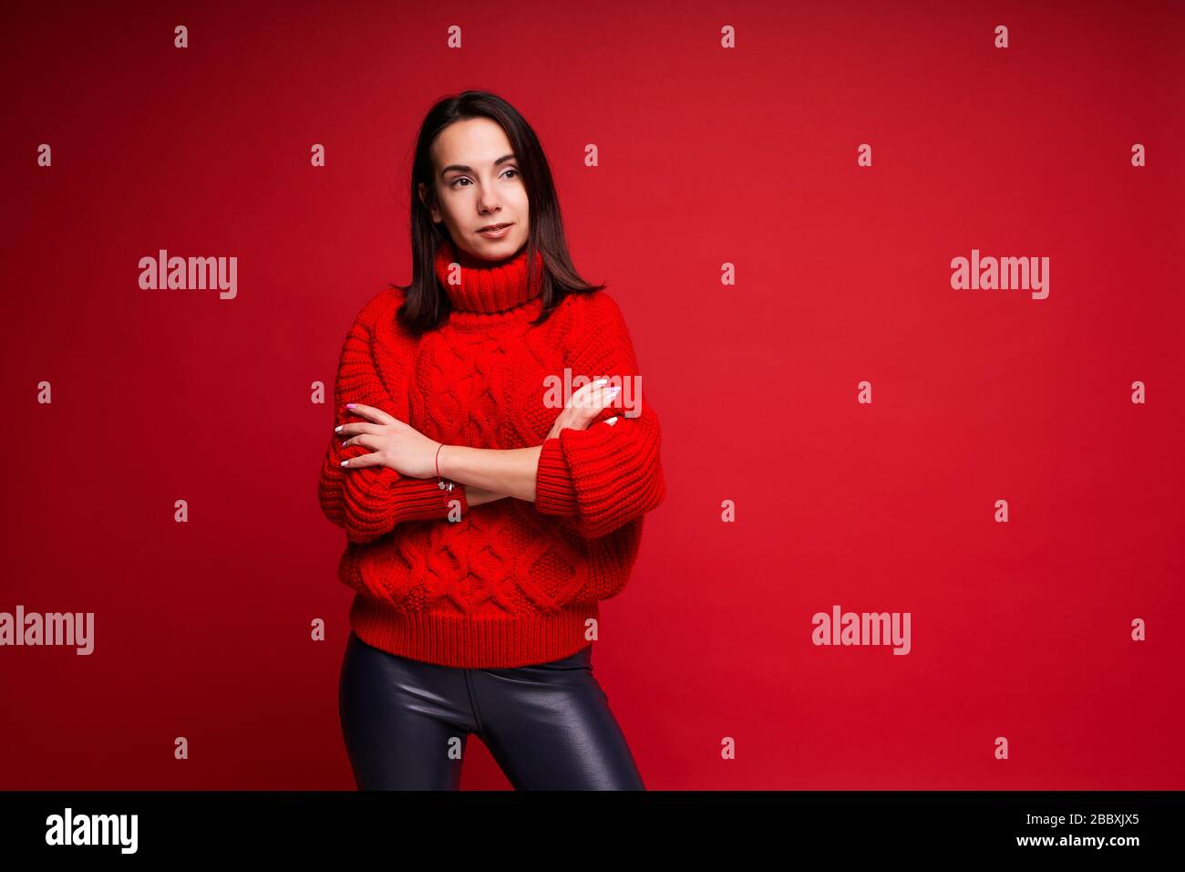 Confident young woman looking forward on red background Stock Photo - Alamy