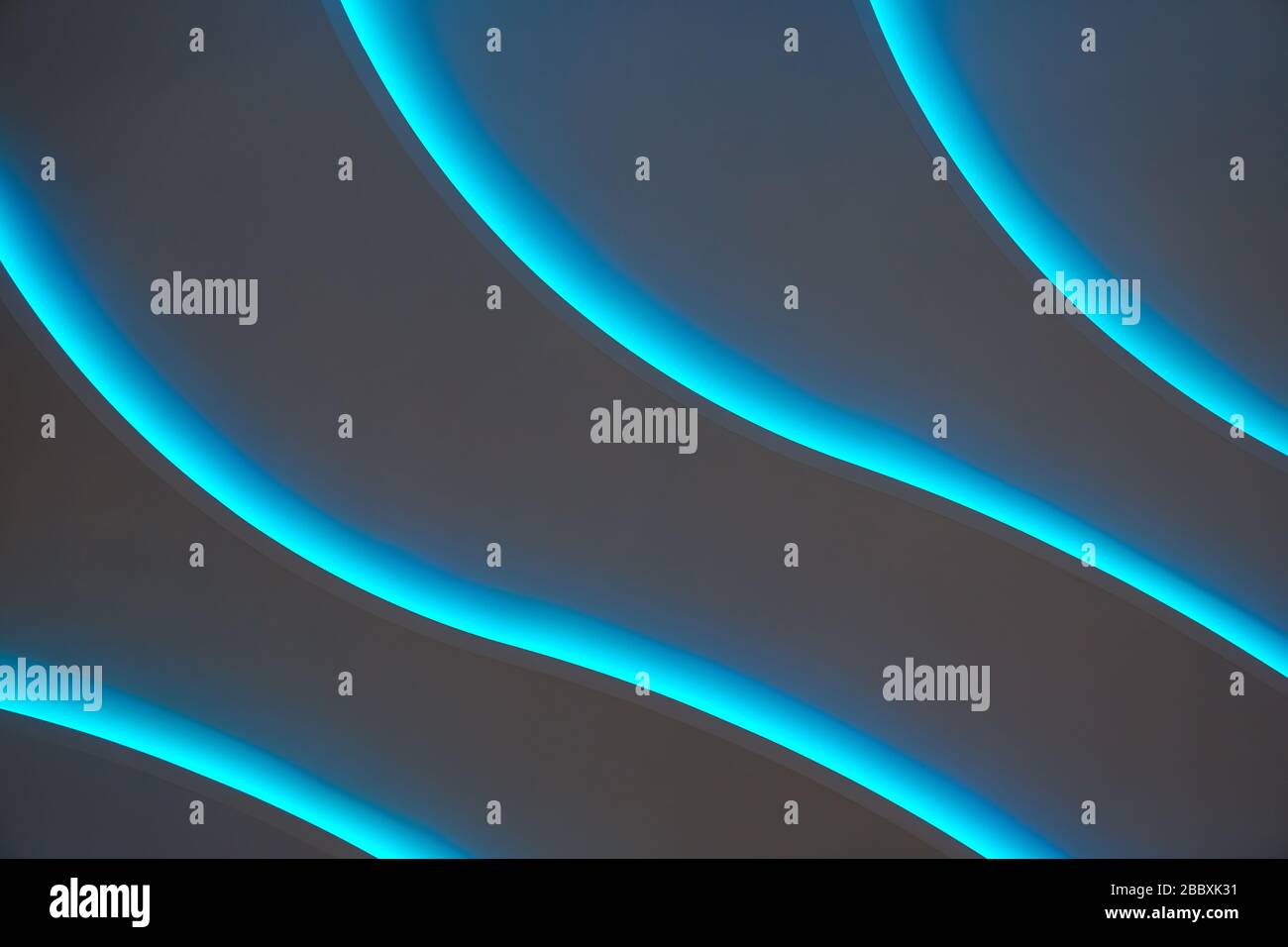 Curved lines of blue backlight on a dark background as a backdrop Stock ...
