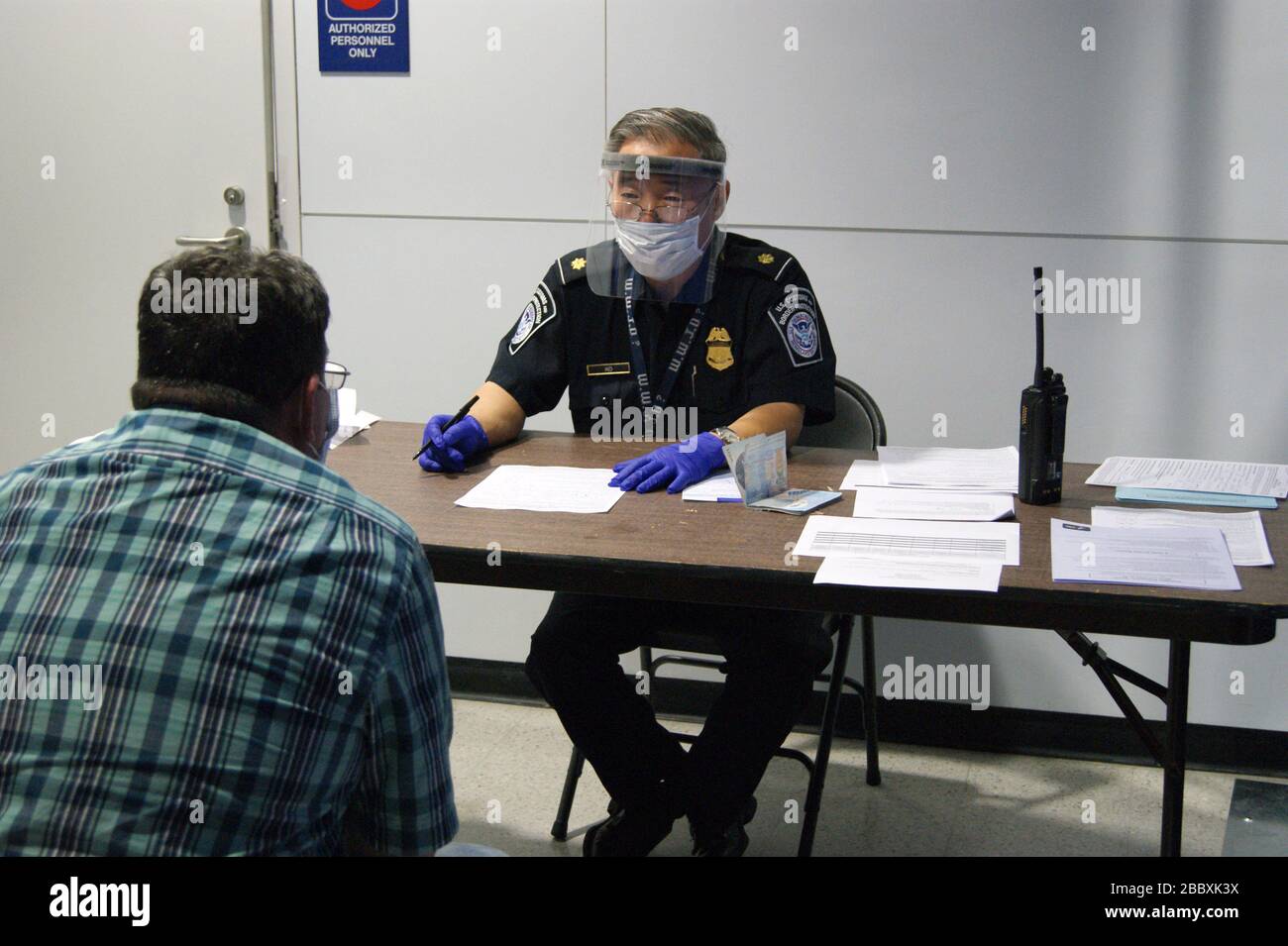 A U.S.C.G. Corpsman and CBP Supervisor conduct prescreening measures on ...