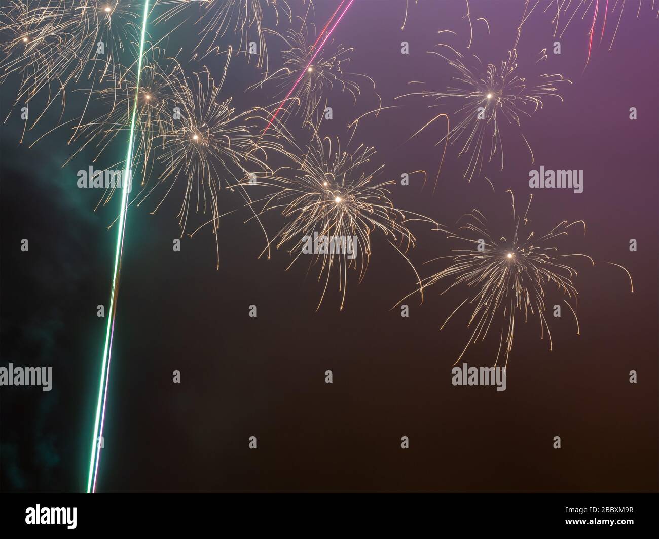 Photo of fireworks in the foggy violet-turquoise sky Stock Photo - Alamy