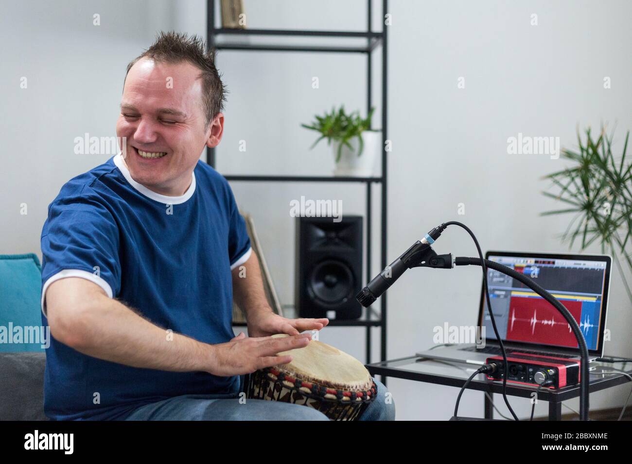 Professional musician recording djembe drum instrument in digital ...