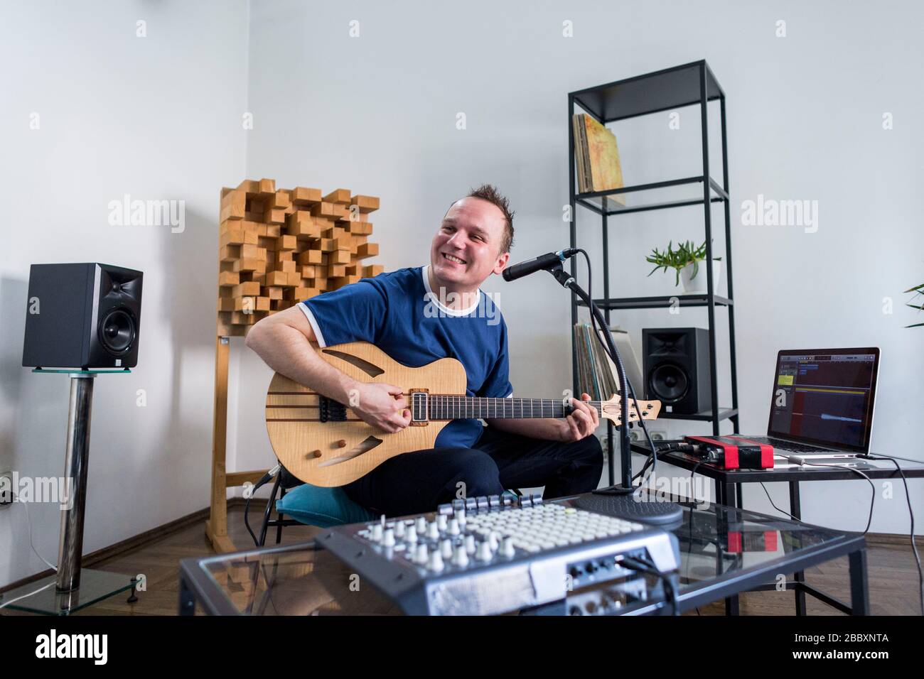 Professional musician recording electric guitar in digital studio at ...