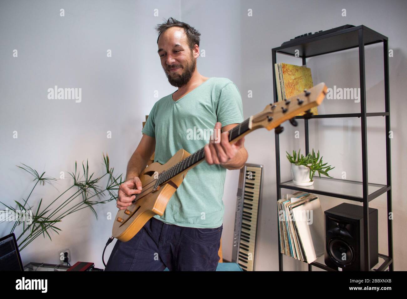 Professional musician recording electric guitar in digital studio at ...