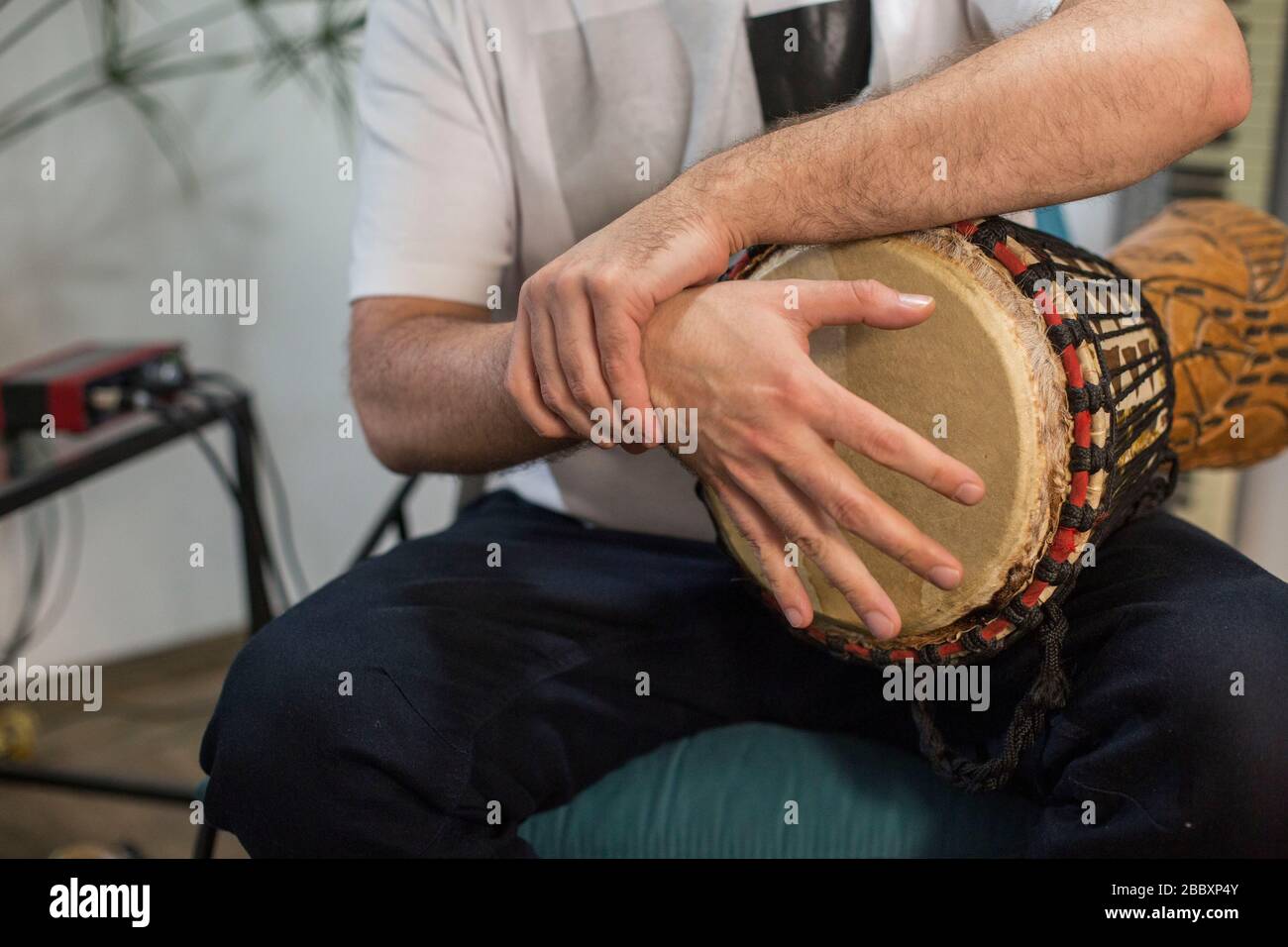 Professional musician having wrist pain while playing djembe music ...