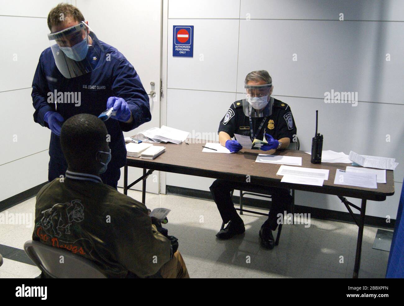 U.S.C.G. Corpsman and CBP Supervisor Sam Ko conduct prescreening ...