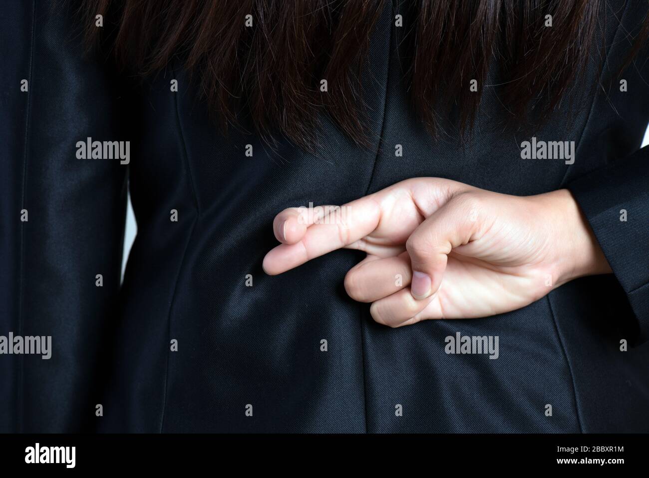 Fingers Crossed Behind Back