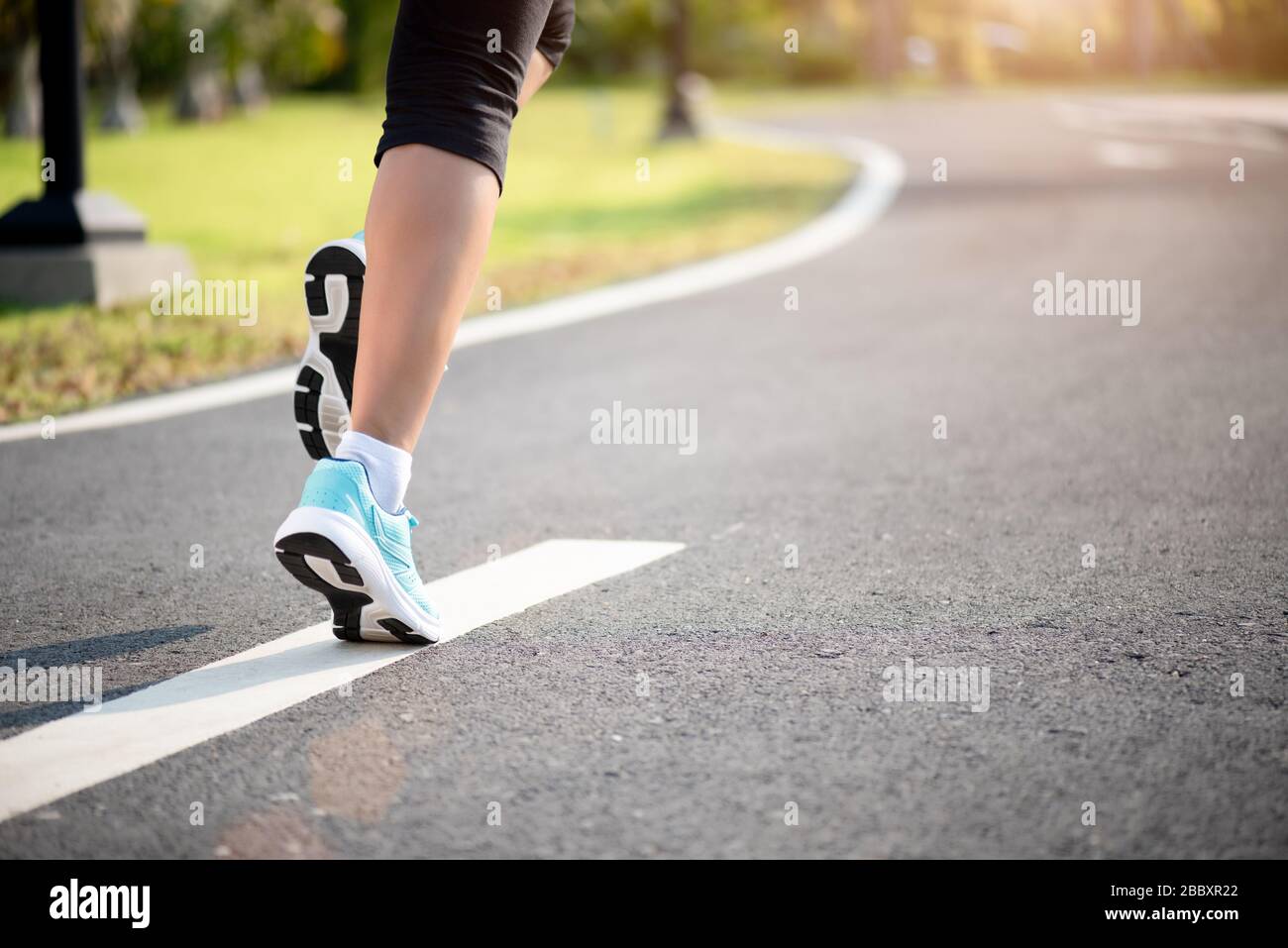 Closeup woman running towards on the road side. Step, run and outdoor ...