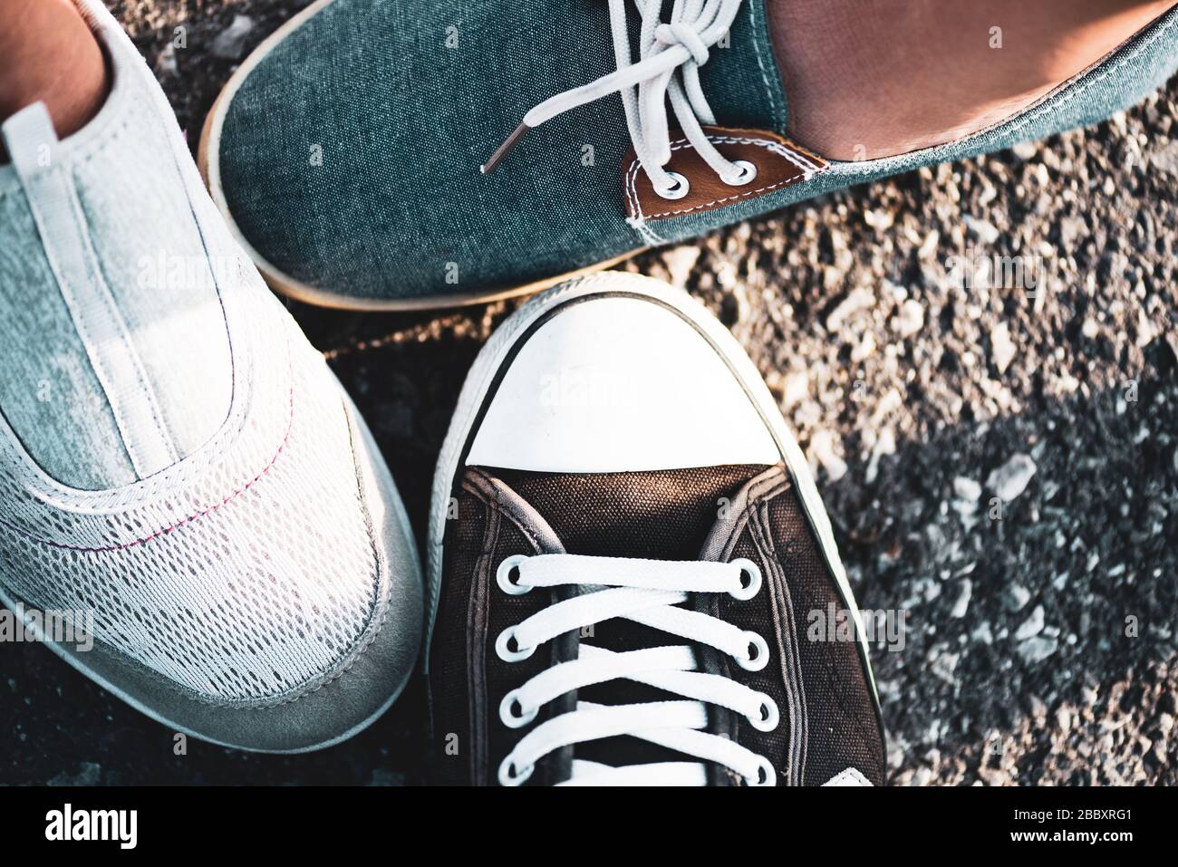Closeup of shoes in a huddle with their feet together showing unity and ...
