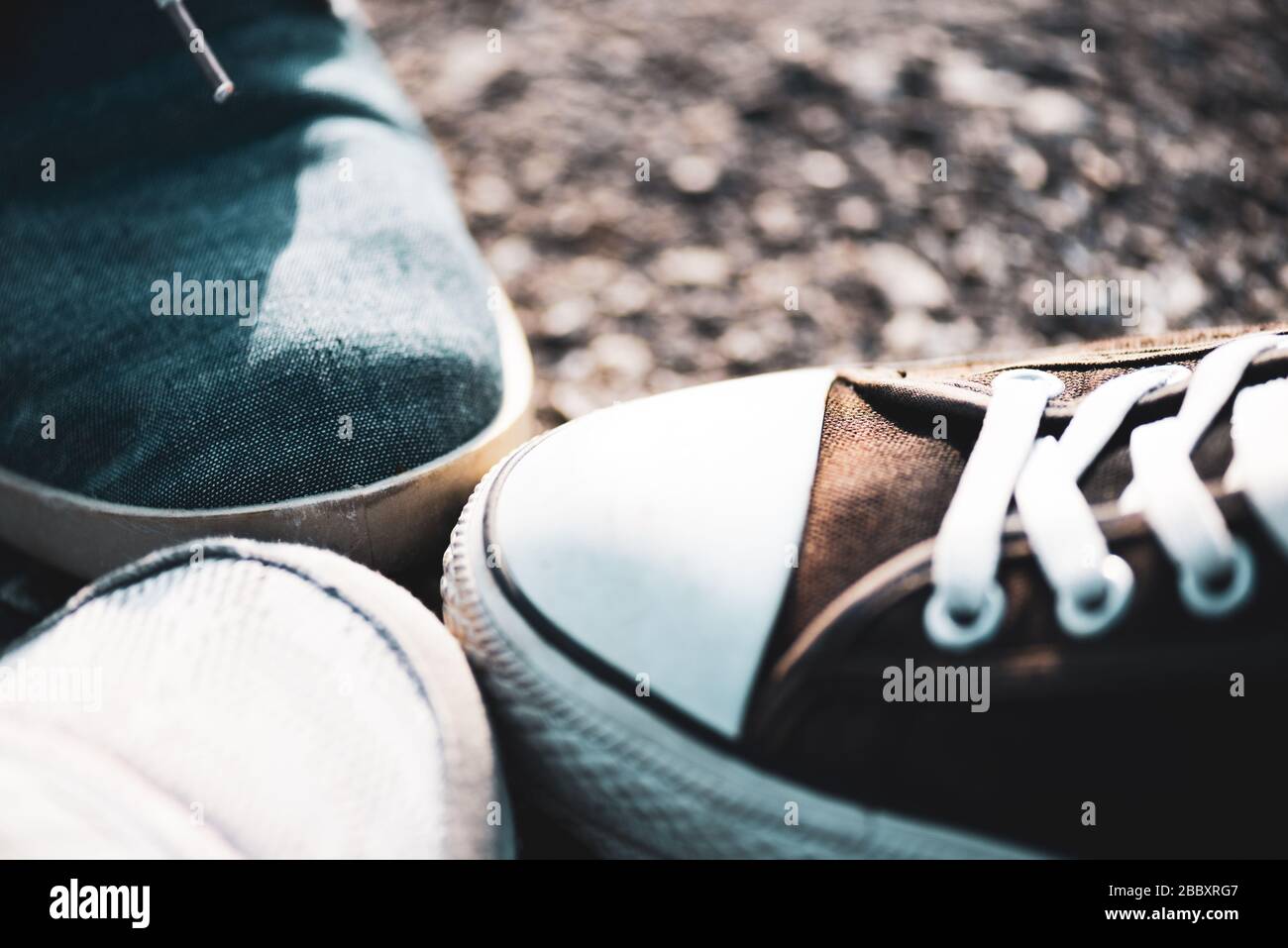Closeup of shoes in a huddle with their feet together showing unity and ...