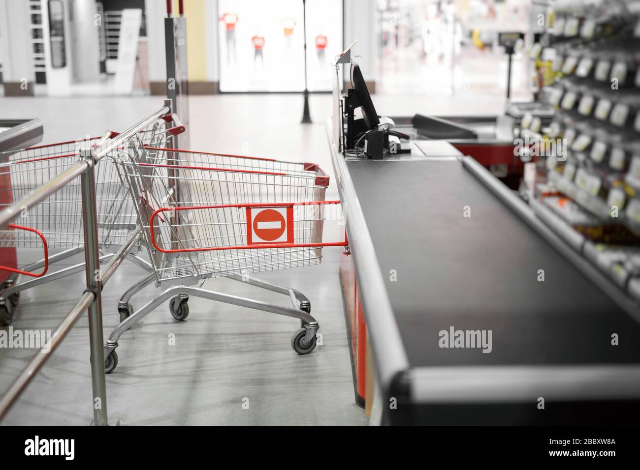 Empty cash desk with closed way border in supermarket Stock Photo - Alamy