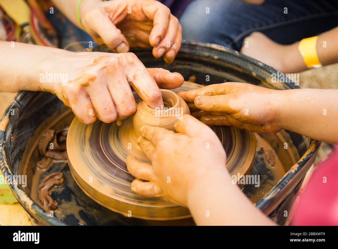 A close up view on ceramic production process on potter's wheel with ...