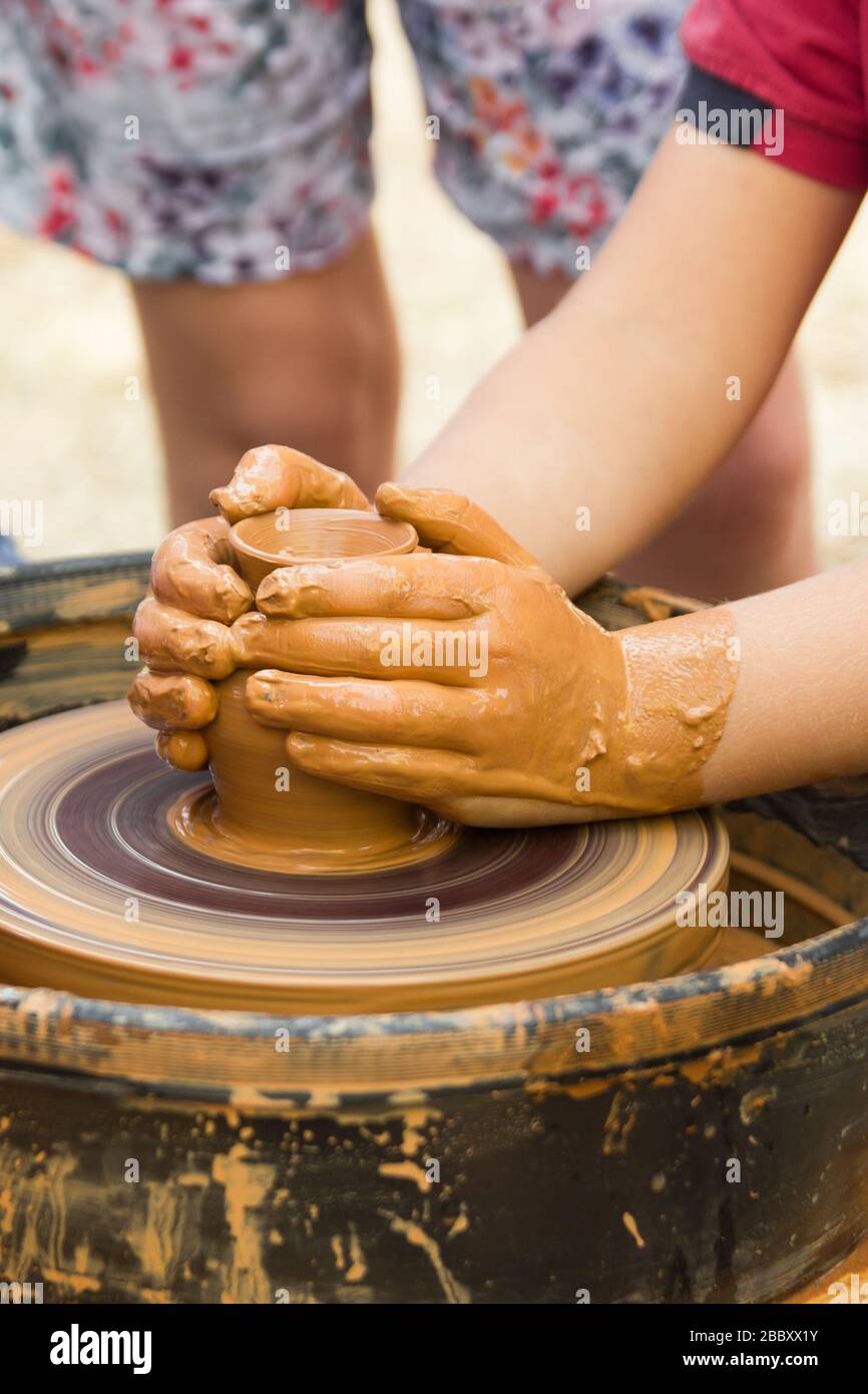 A close up view on ceramic production process on potter's wheel with ...