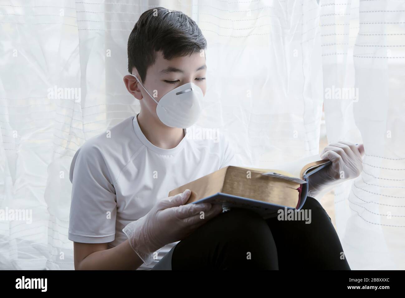 A concept photo of a teen boy with a mask, gloves, and a book showing ...