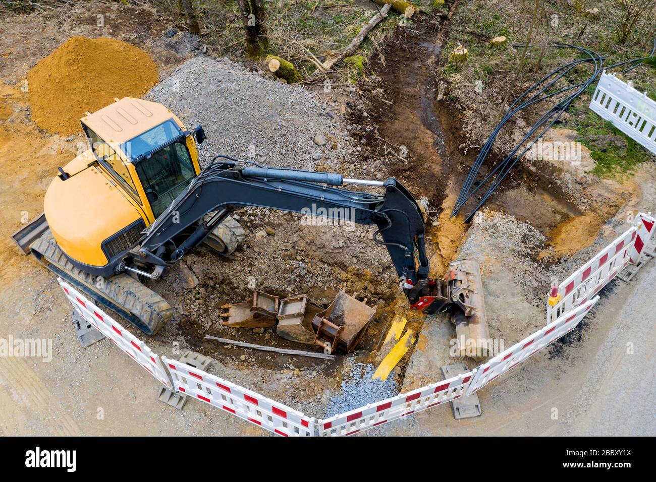 an excavator on an cable construction site from above Stock Photo - Alamy
