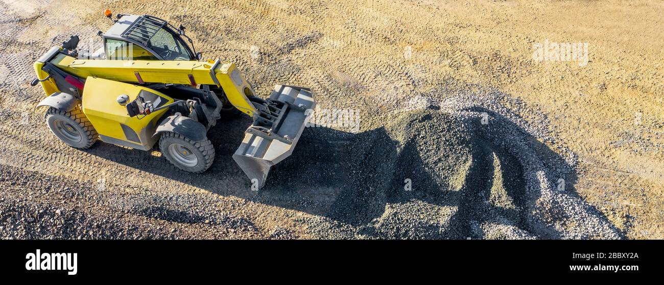 excavator on an construction site from above panorama Stock Photo - Alamy