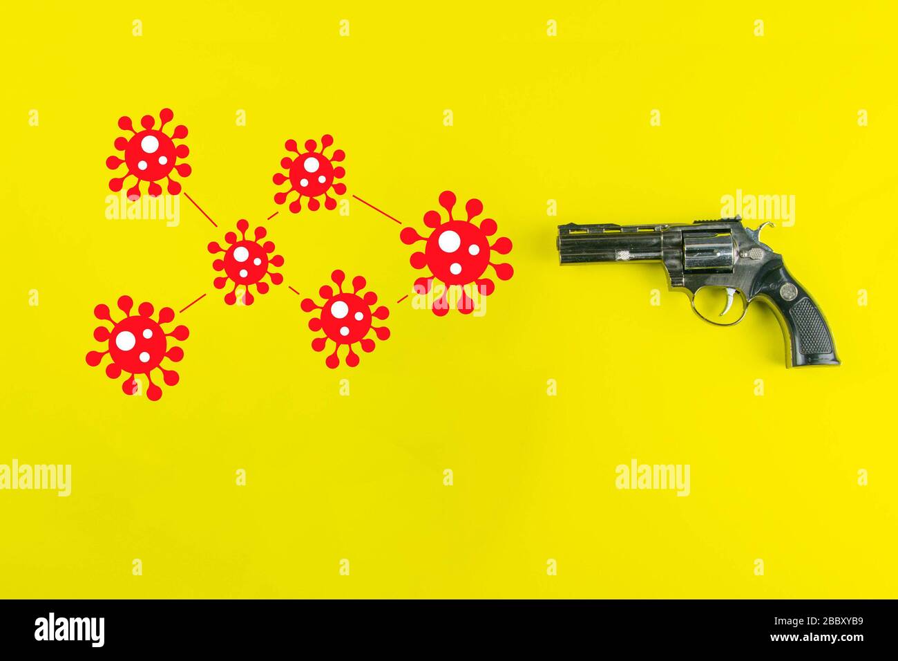 A black gun and a drawn COVID-19 virus. The coronavirus epidemic kills ...