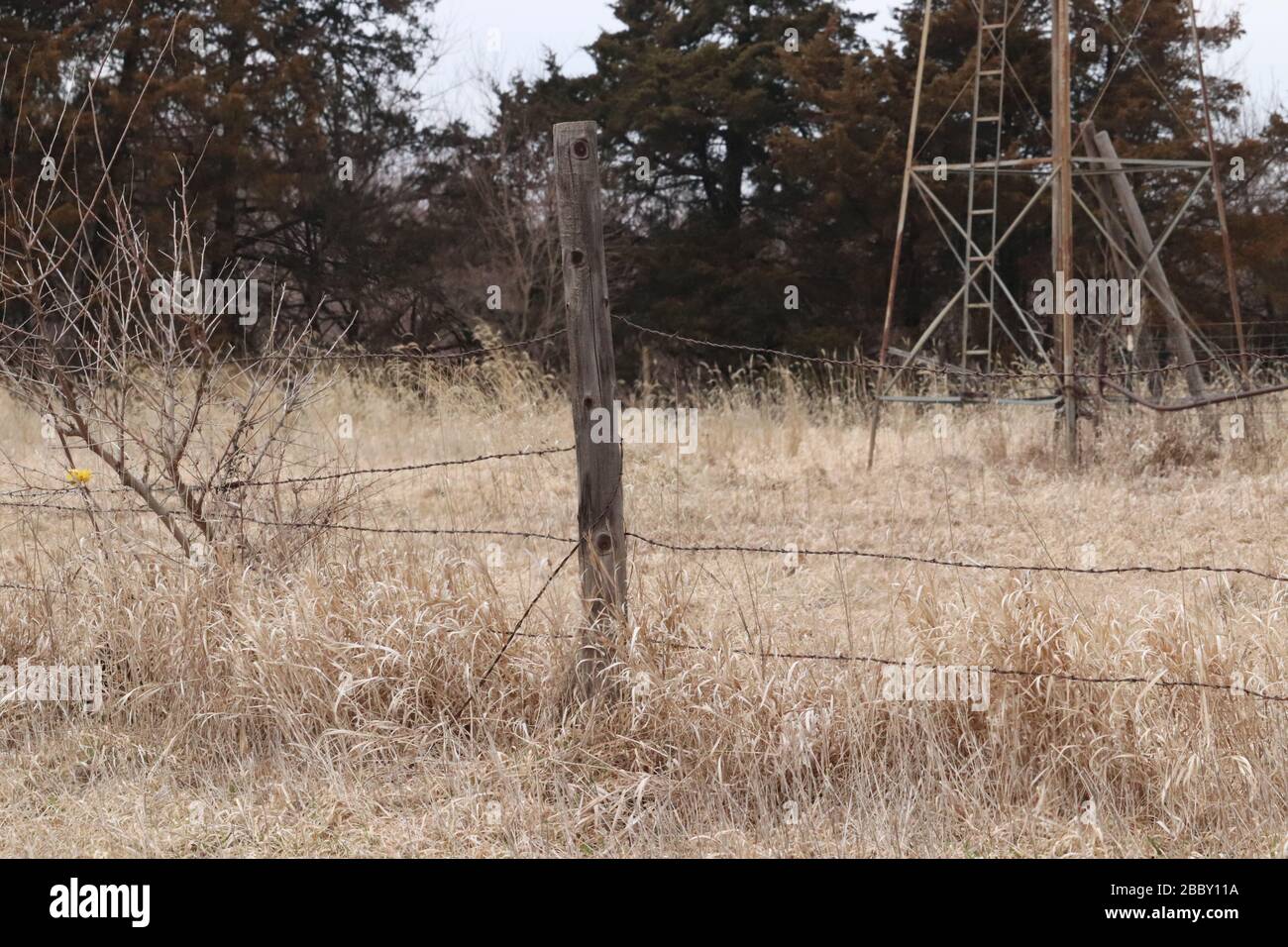 Weathered old wooden fence post with barbed wire hi-res stock ...