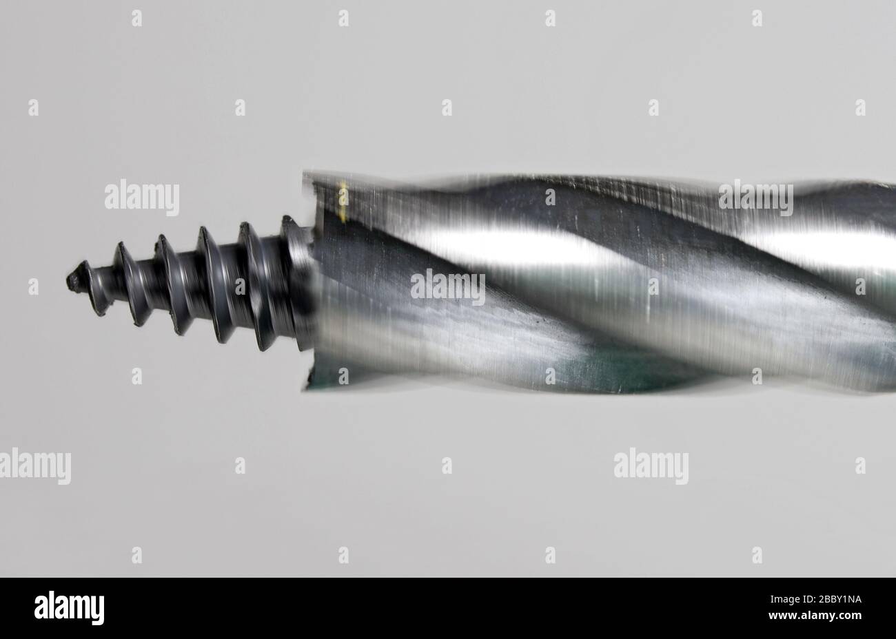 The metal bit of drilling machine spin close up. A rotating A spike of ...