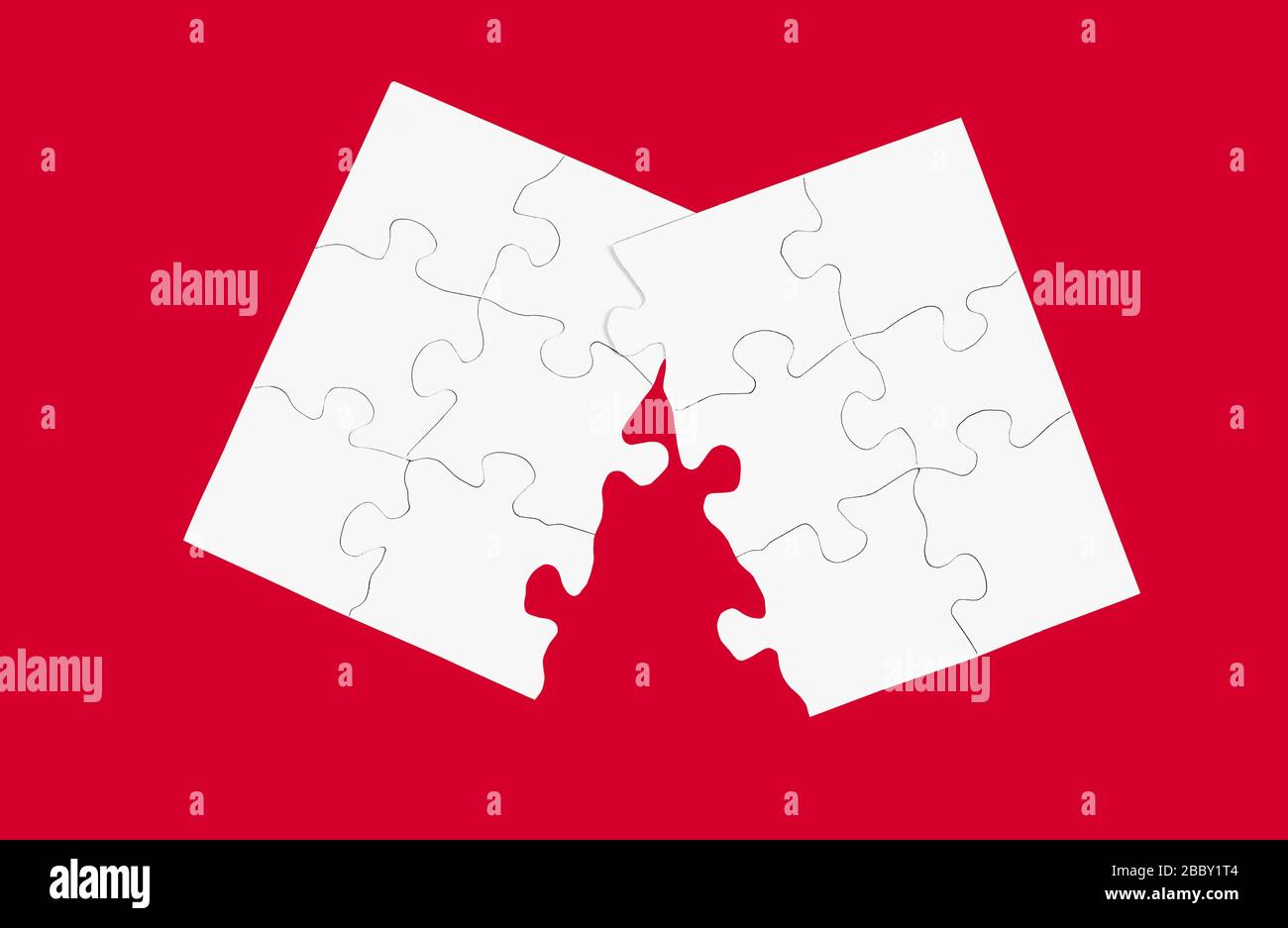 Blank white puzzle split in half isolated on red Stock Photo - Alamy