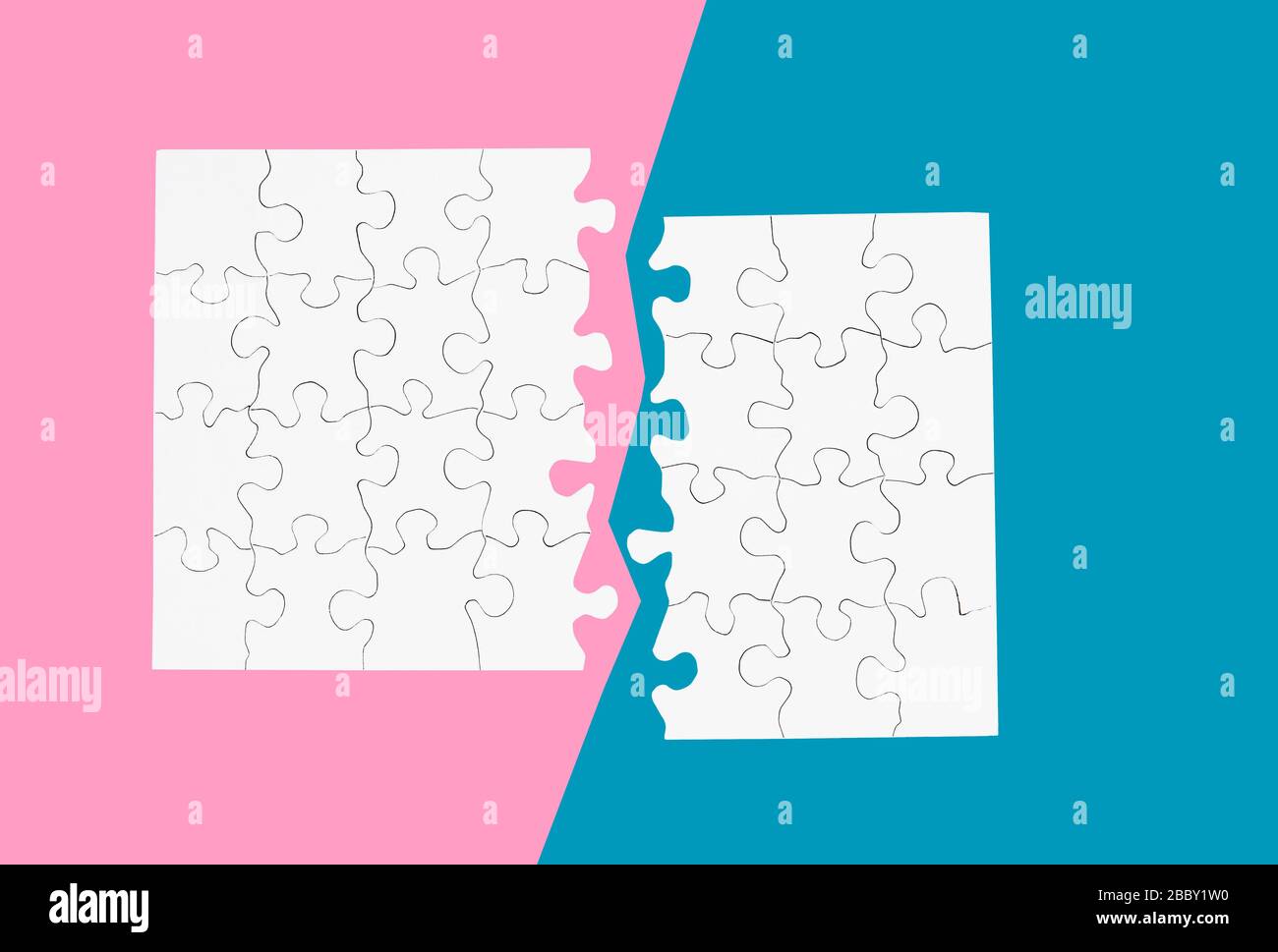Blank white puzzle with pieces split apart isolated on pink and teal ...