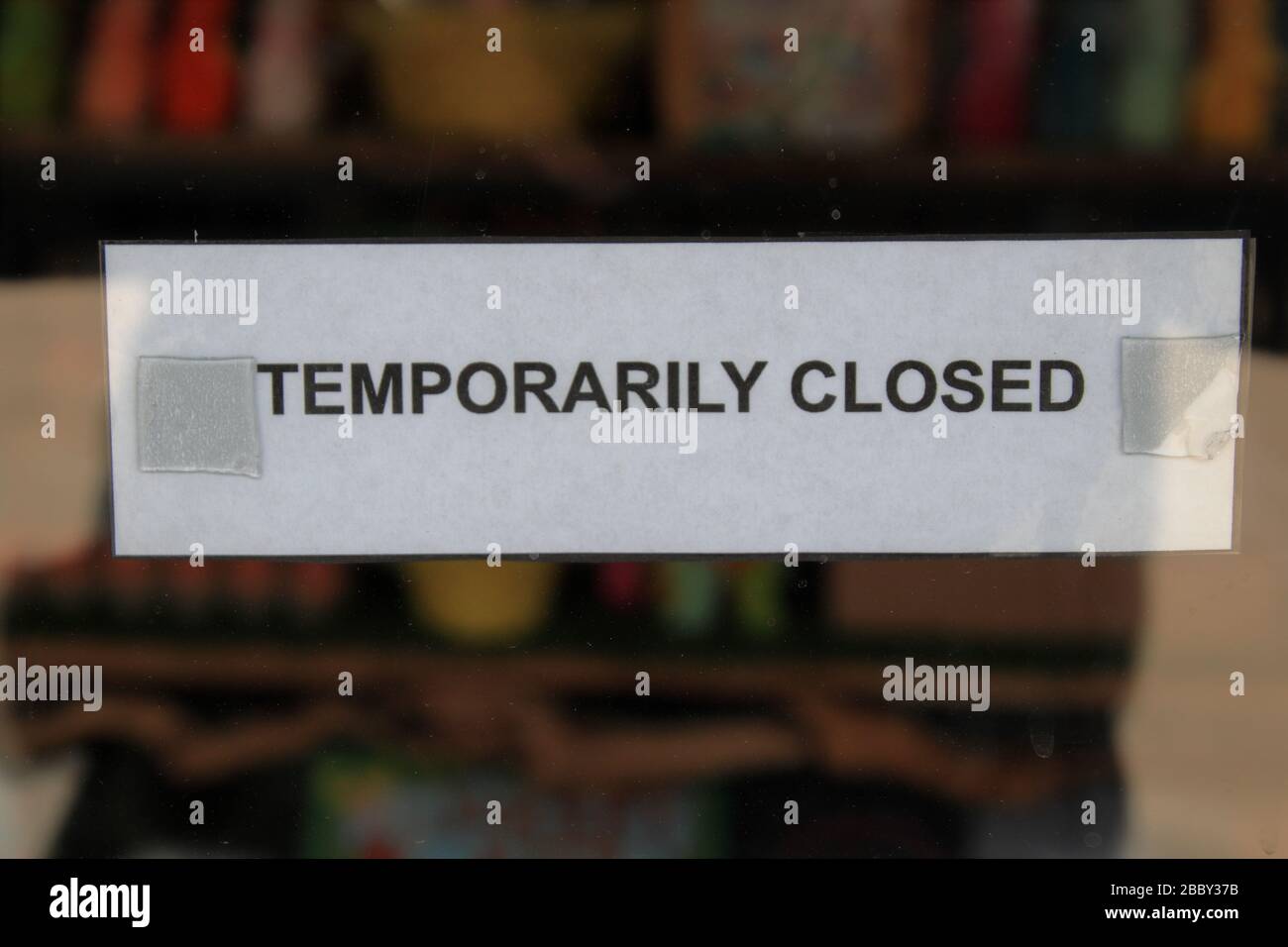 Temporarily Closed sign taped to the door of a business during the ...