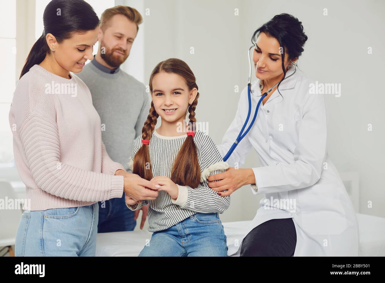 Happy family on a visit to the doctor in the office of a doctor Stock ...