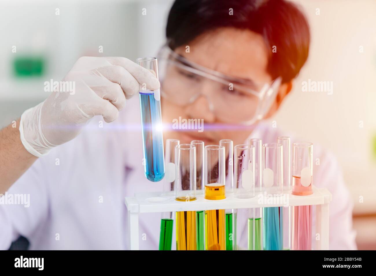 Scientist looking at chemical science test tube successful to discover ...