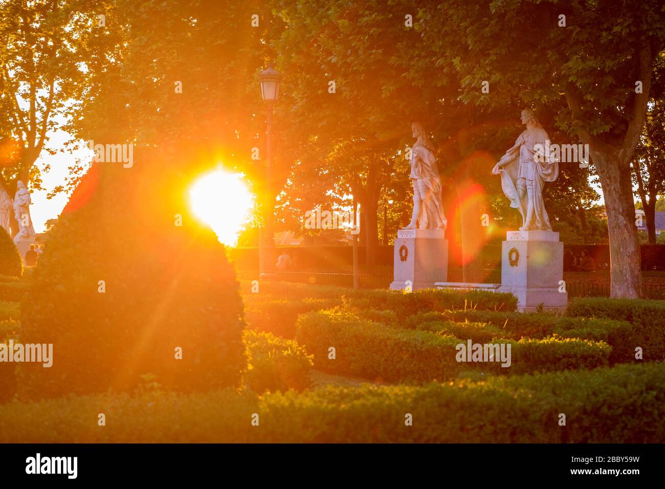 Sunset by the Royal Palace or Palacio Real with statues in Plaza de ...
