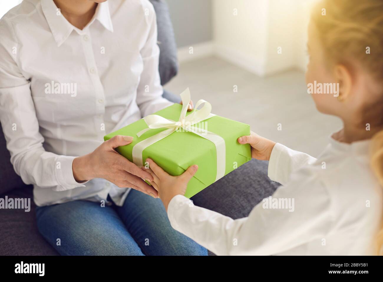 Happy mother's day. Hands of a child give mother a present on mother's ...