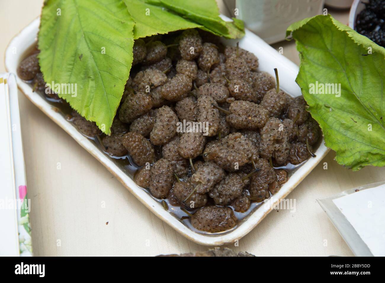 Ripe mulberries in bowl on table Stock Photo - Alamy