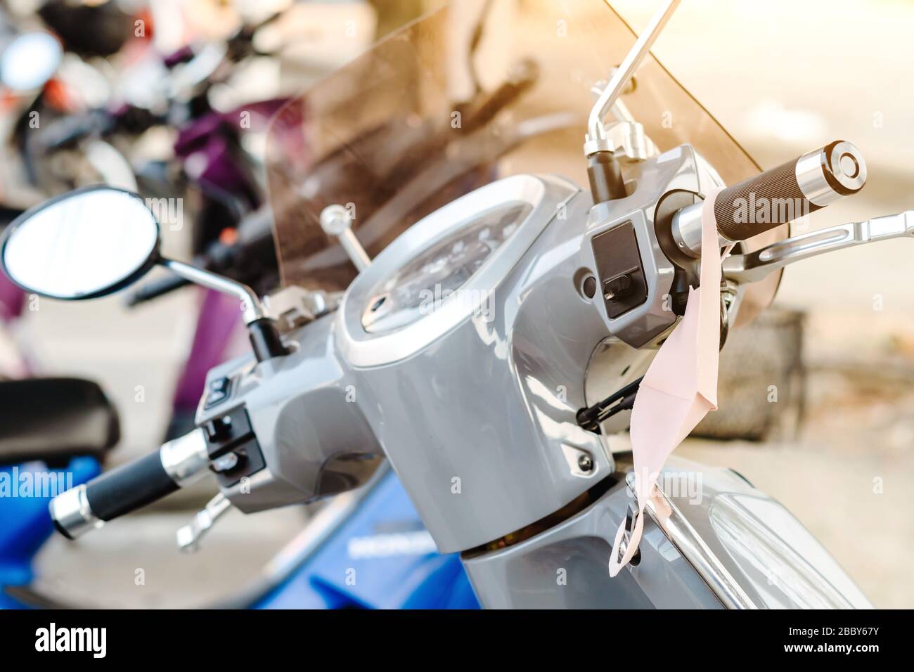 A mask hanging on a motorcycle handle to prevent germs (Covid-19) on ...