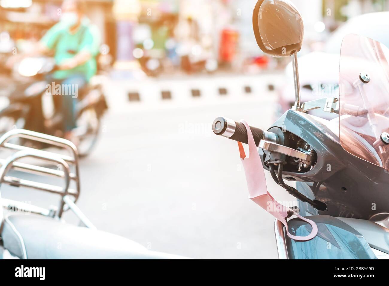 A mask hanging on a motorcycle handle to prevent germs (Covid-19) on ...