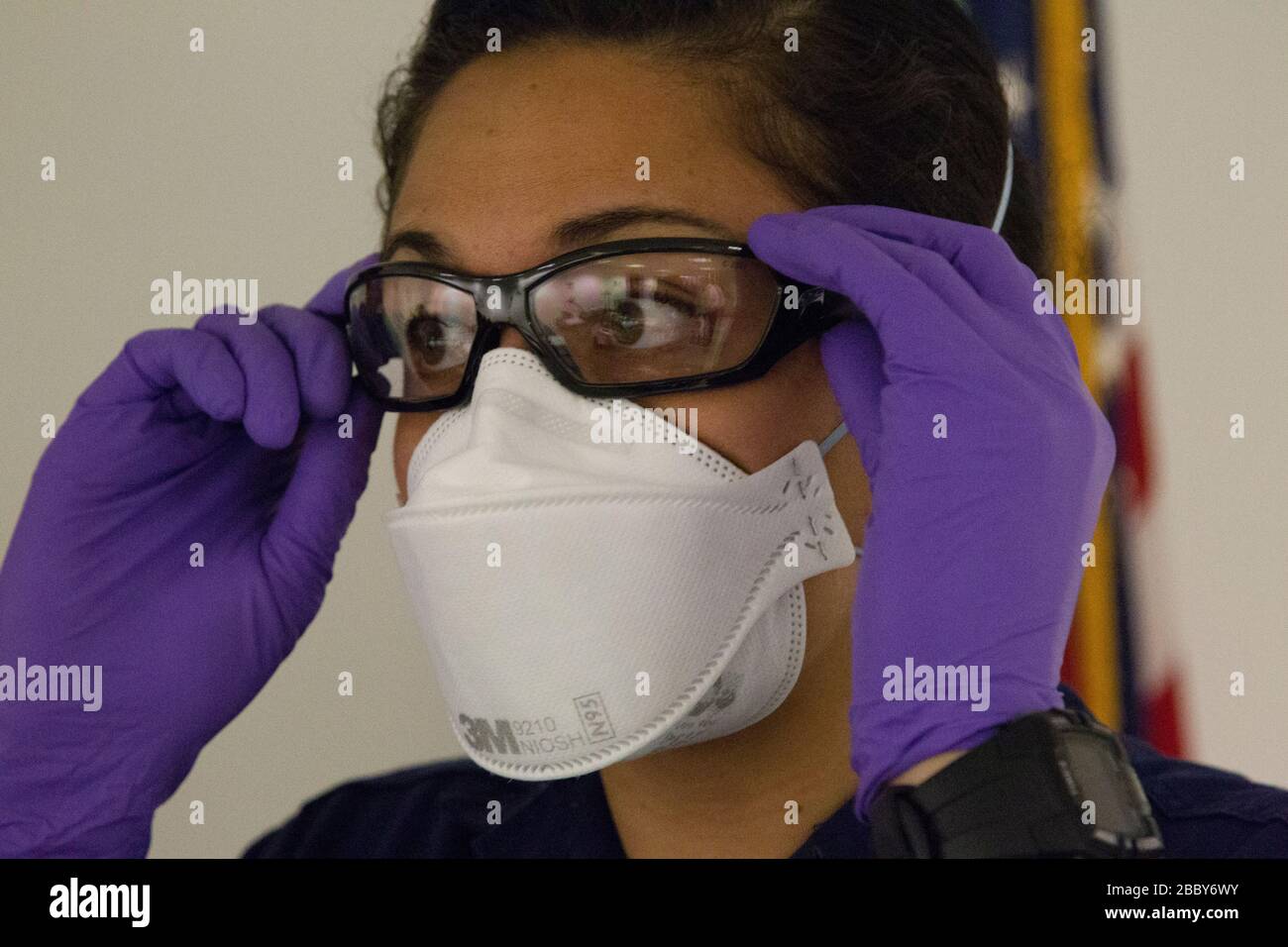 A Coast Guard medical person prepares for enhanced screening at JFK ...