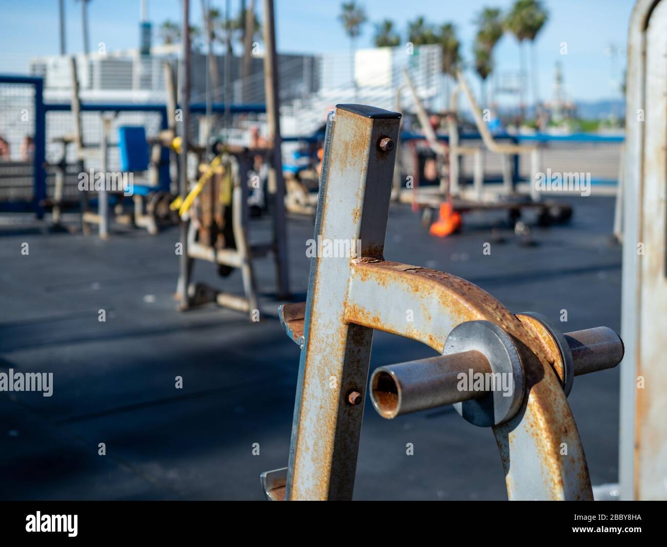 Rusted outdoor weight rack empty at public gym with workout equipment ...