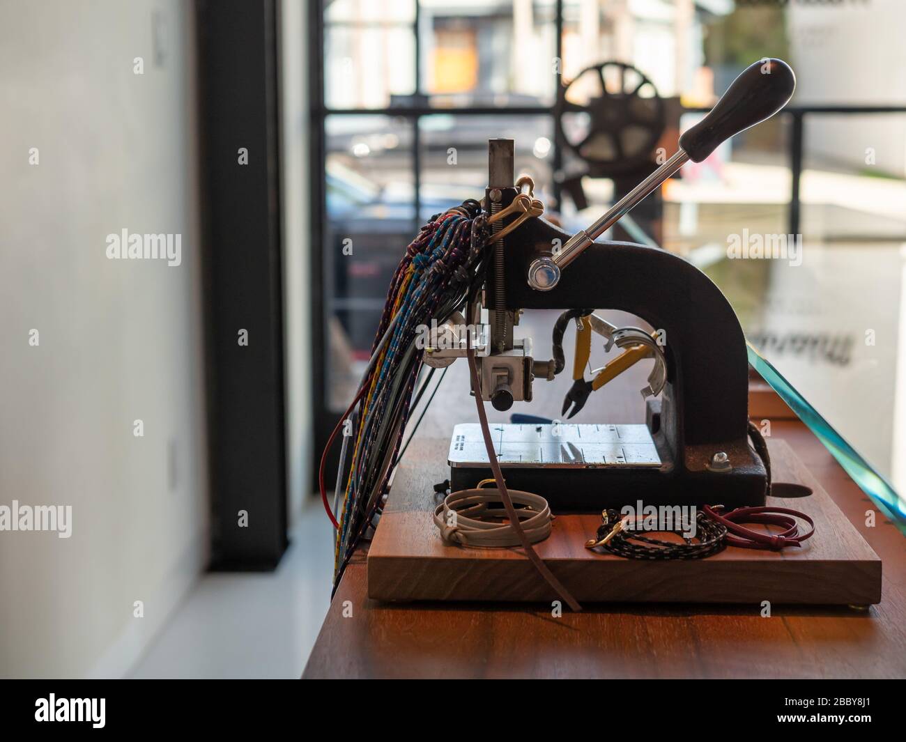 Bracelet making machine with braids and materials hanging off Stock ...